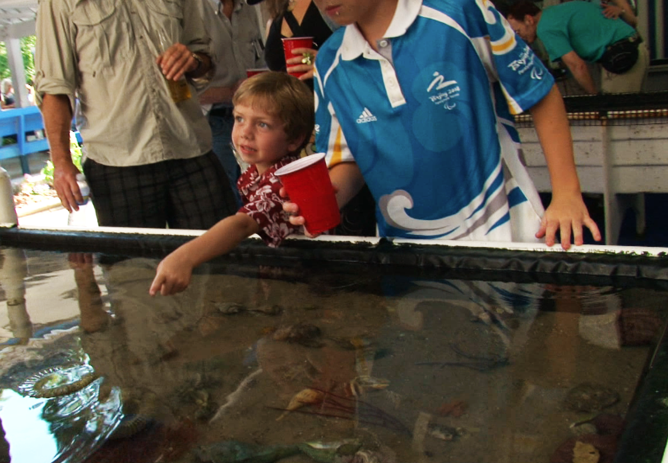 S&C - kid pointing in front of tank
